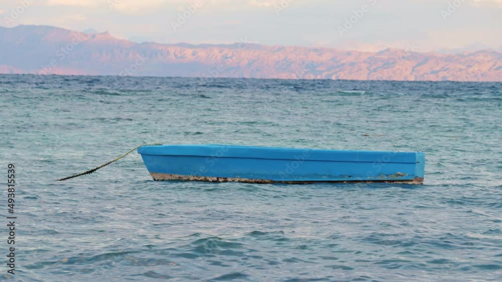 Video Stock Empty blue boat is rocking on Red sea waves. Fishing old ...