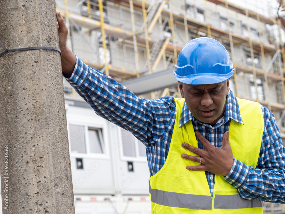 Indian or somali construction worker having a heart attack on work ...