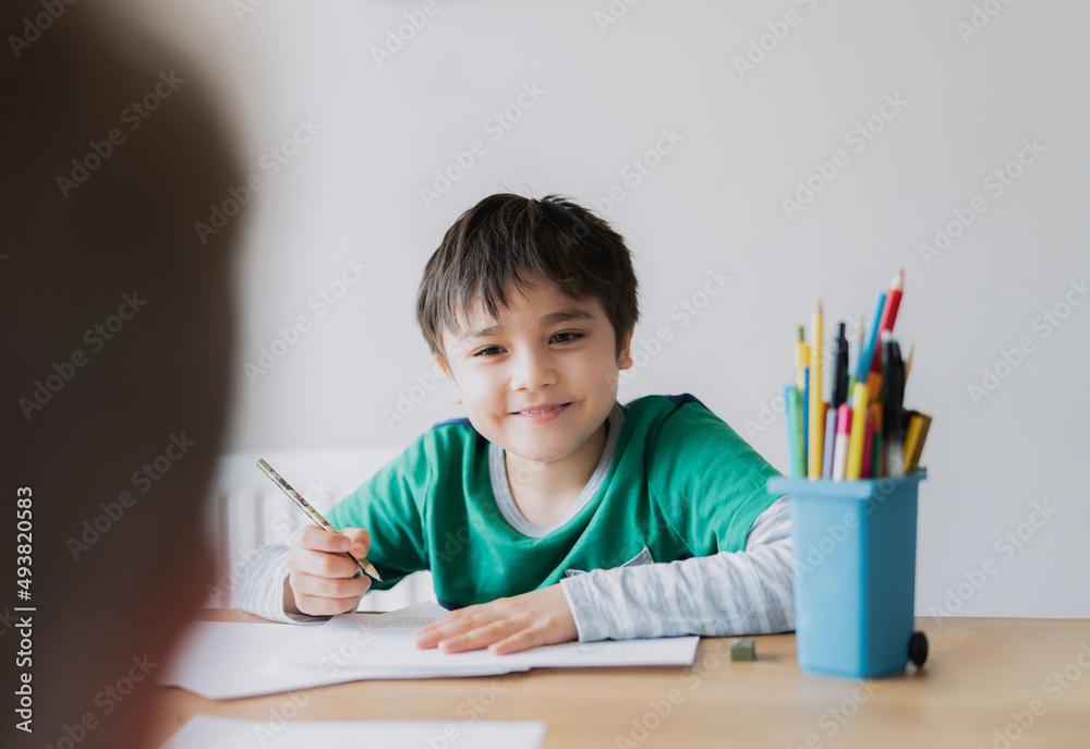 Happy boy using pencil drawing or sketching on paper, Cute kid with ...