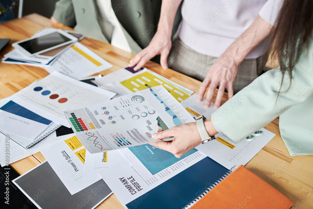Office colleagues reviewing infographics on desk at office Stock Photo ...