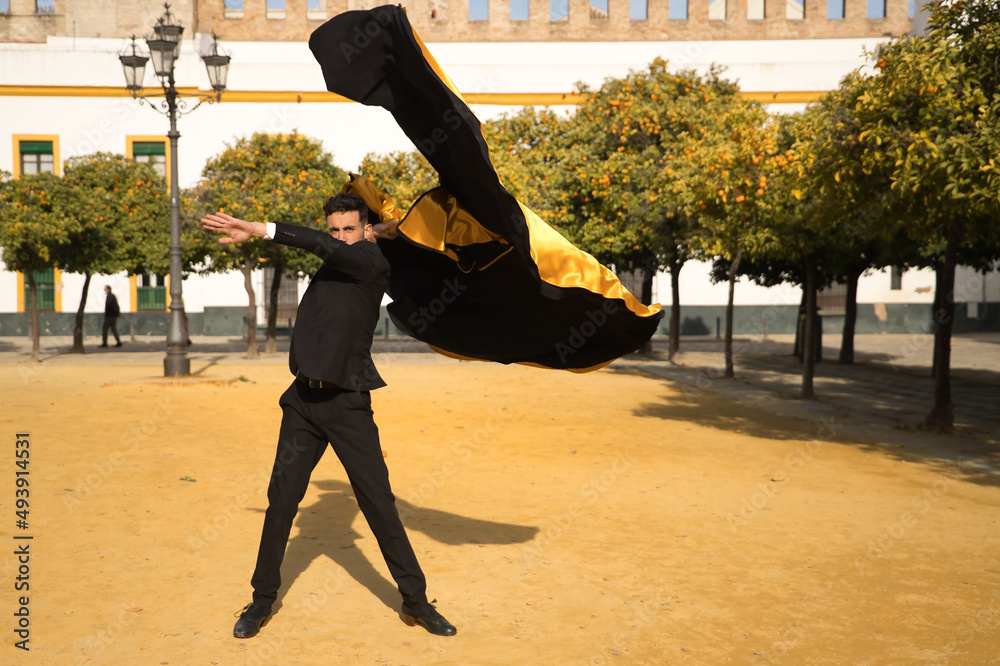 Young Spanish man in black shirt, jacket and pants, with dancing shoes ...