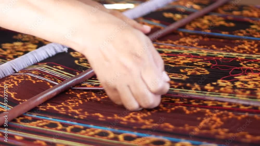 An Indonesian woman weaving traditional flores fabric. Traditional ...