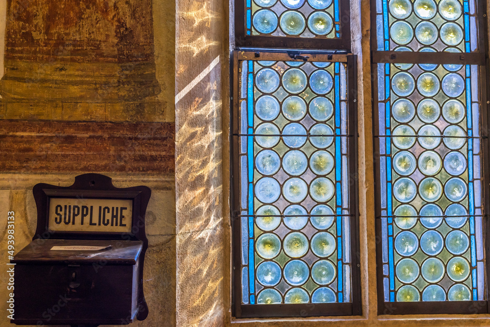 Prayer box next to a stained glass window inside the Sanctuary of San ...