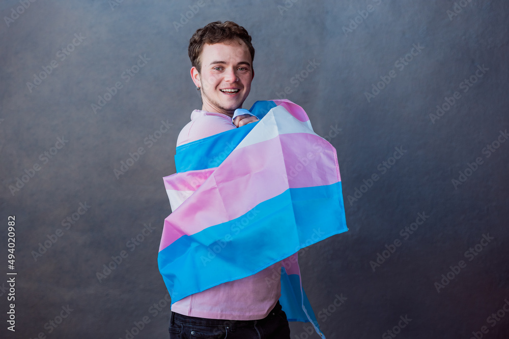 Man wrapping with transgender flag Stock Photo | Adobe Stock