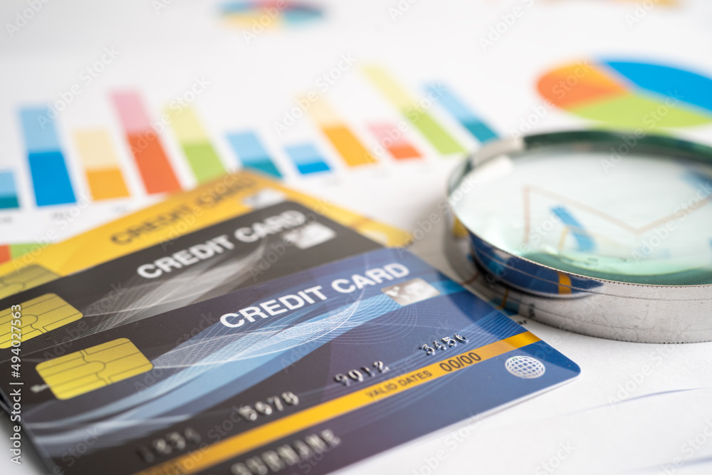 Credit card on chart and graph paper. Finance development, Banking ...