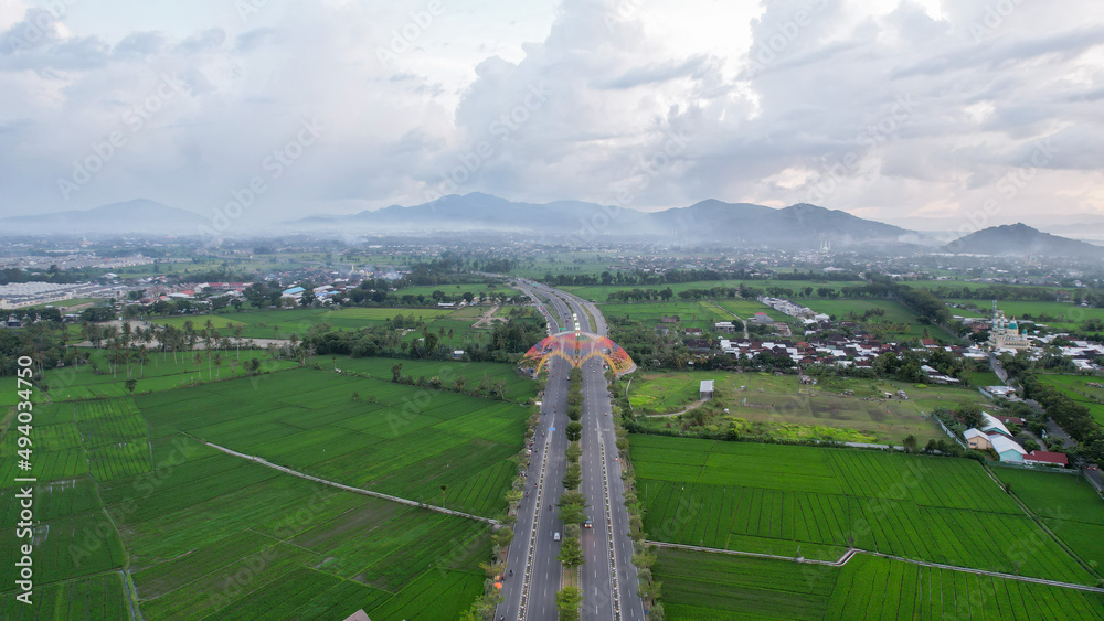 Aerial view of the city colorful Monument Tembolak Rainbow on Mataram ...