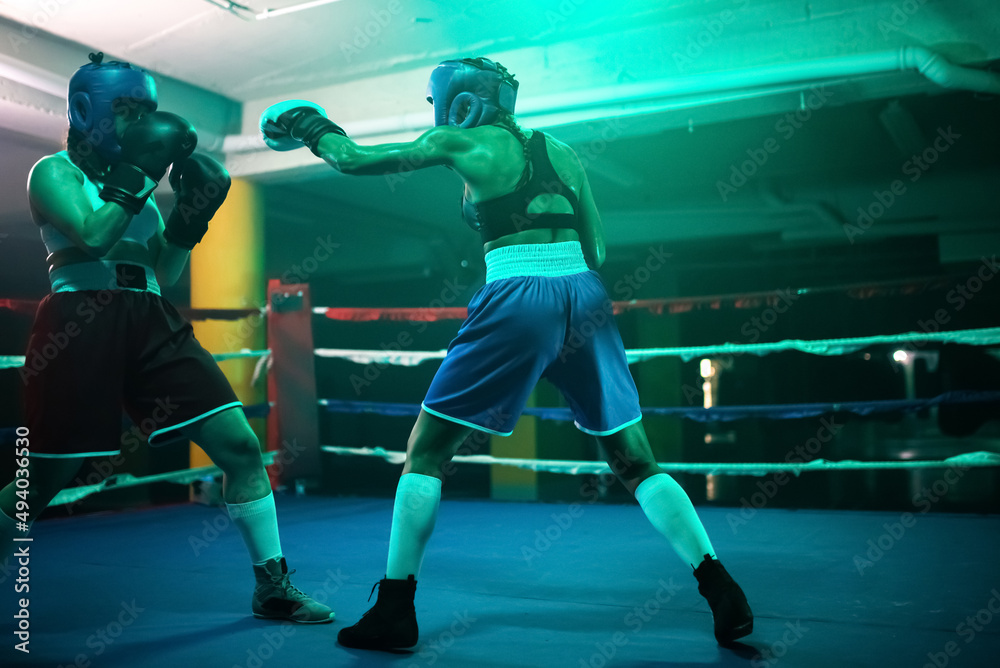 Strong boxer girls fighting for victory on ring. Two Caucasian girls in ...