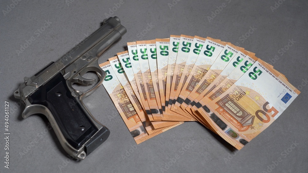 Money cash banknote 50 Euro and revolver gun army - order a murder ...