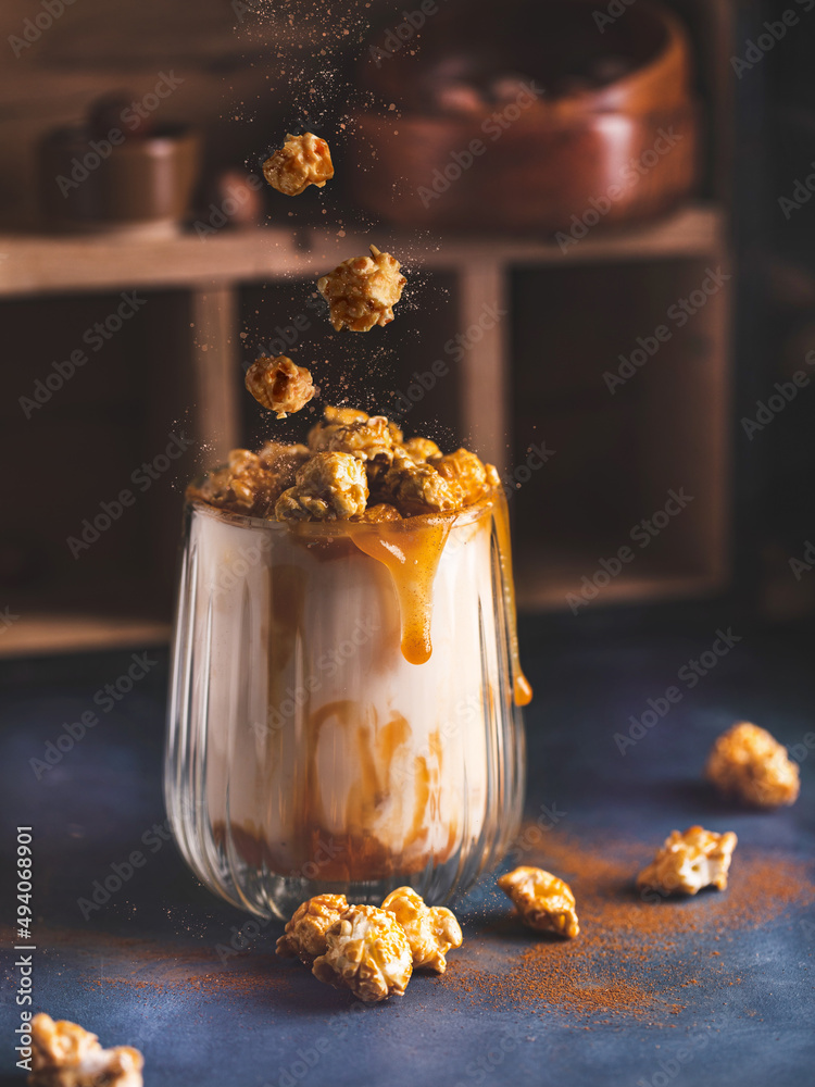 Popcorn milkshake beverage glass decorated with caramel salted syrup ...