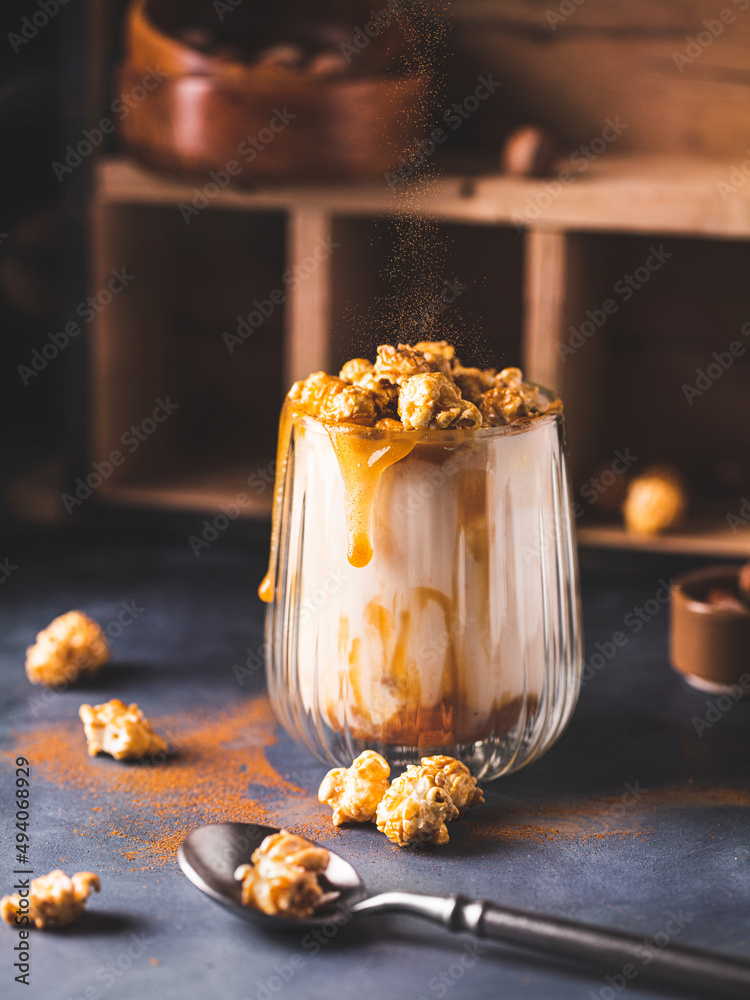Popcorn milkshake beverage glass decorated with caramel salted syrup ...
