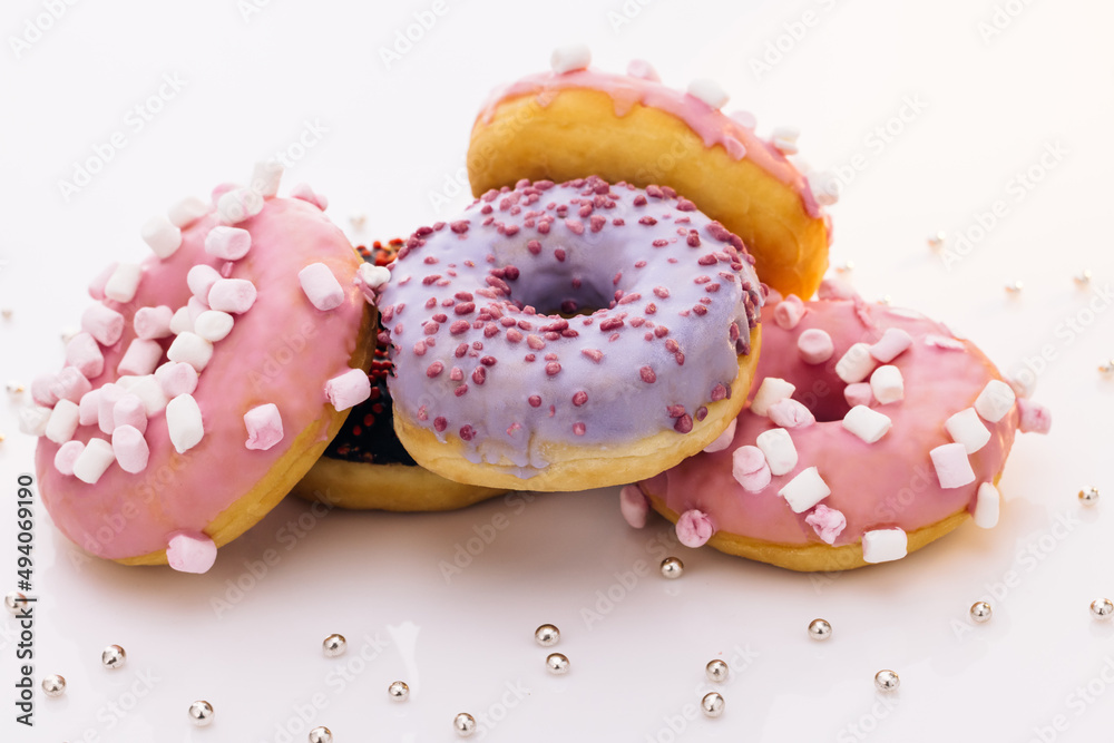 Donuts of different colors. Glazed sweet desserts. Fast food, Bakery ...