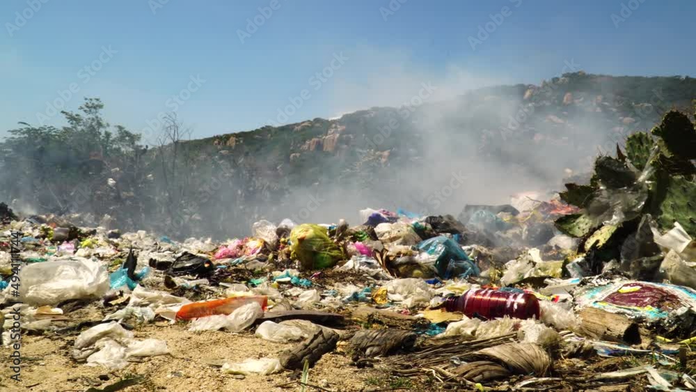 Pile of plastic waste in garbage dumb landfill, toxic smoke and fire ...