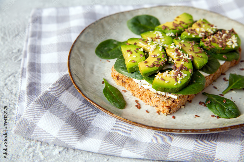 Toast with avocado, cottage cheese, spinach, sesame seeds, flax seeds ...
