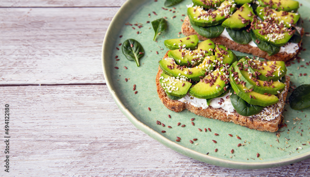 Toast with avocado, cottage cheese, spinach, sesame seeds, flax seeds ...