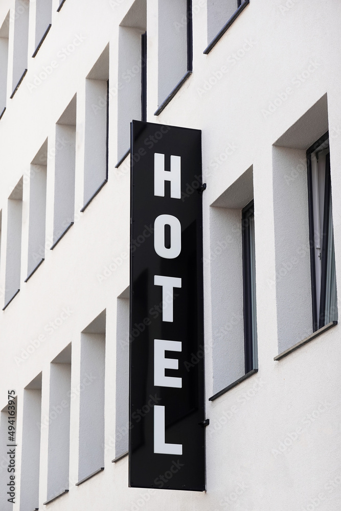 vertical hotel sign on generic modern city hotel facade Stock Photo ...