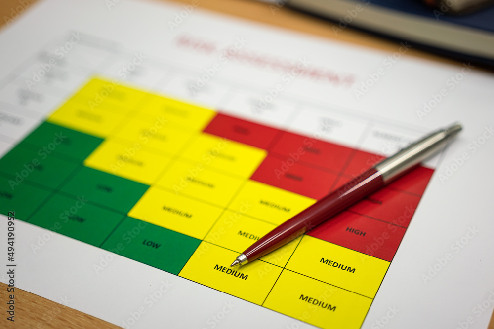 A luxury ballpoint pen on safety risk assessment blank form with color ...