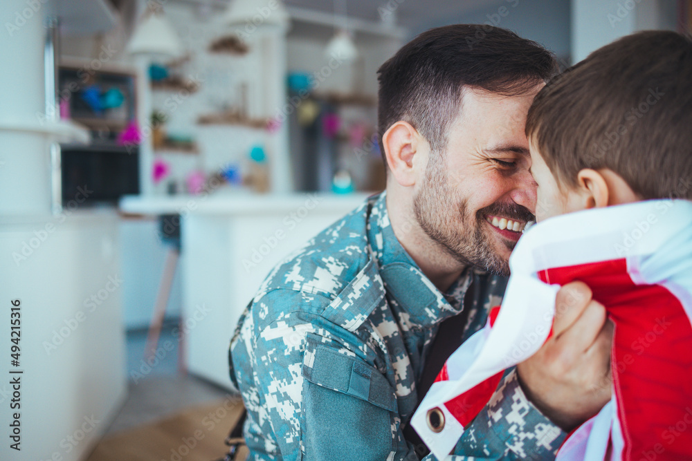 Happy soldier play with his son. Soldier enjoying at home with children ...