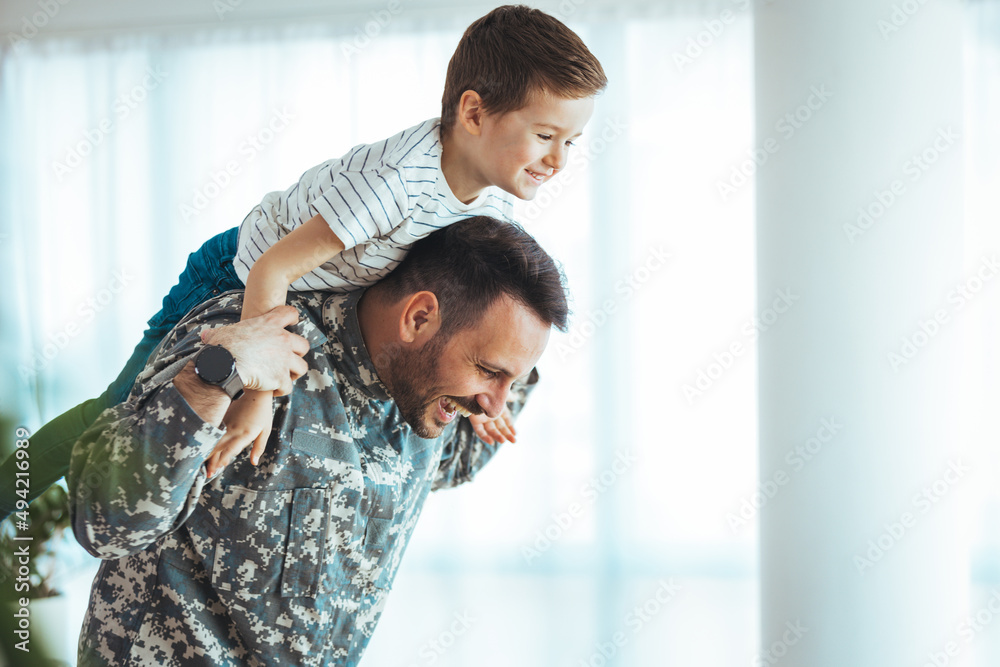 Military man father hugs son. Portrait of happy american family. Young ...