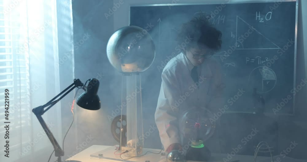 Physics science lab: handsome young scientist in white coat and glasses ...