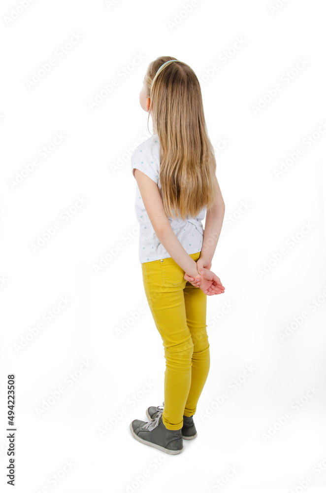 Back view of little girl looking at wall. Rear view. Isolated on white ...