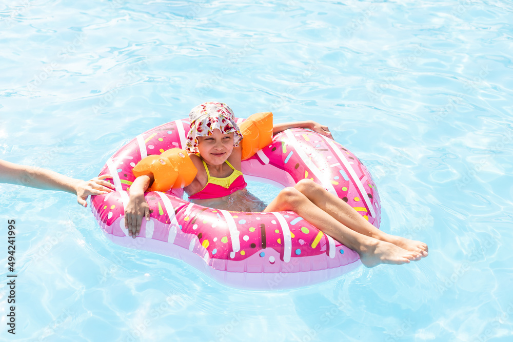 Pretty little girl in swimming pool Stock Photo | Adobe Stock