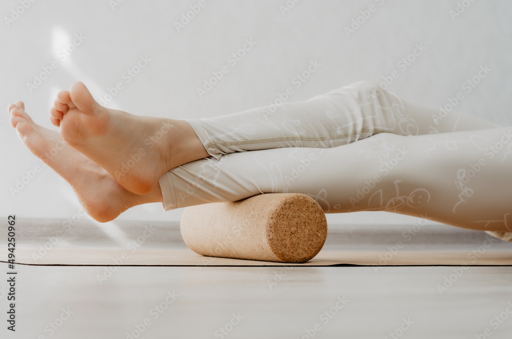 Close up of person doing calf muscles myofascial release on a cork ...