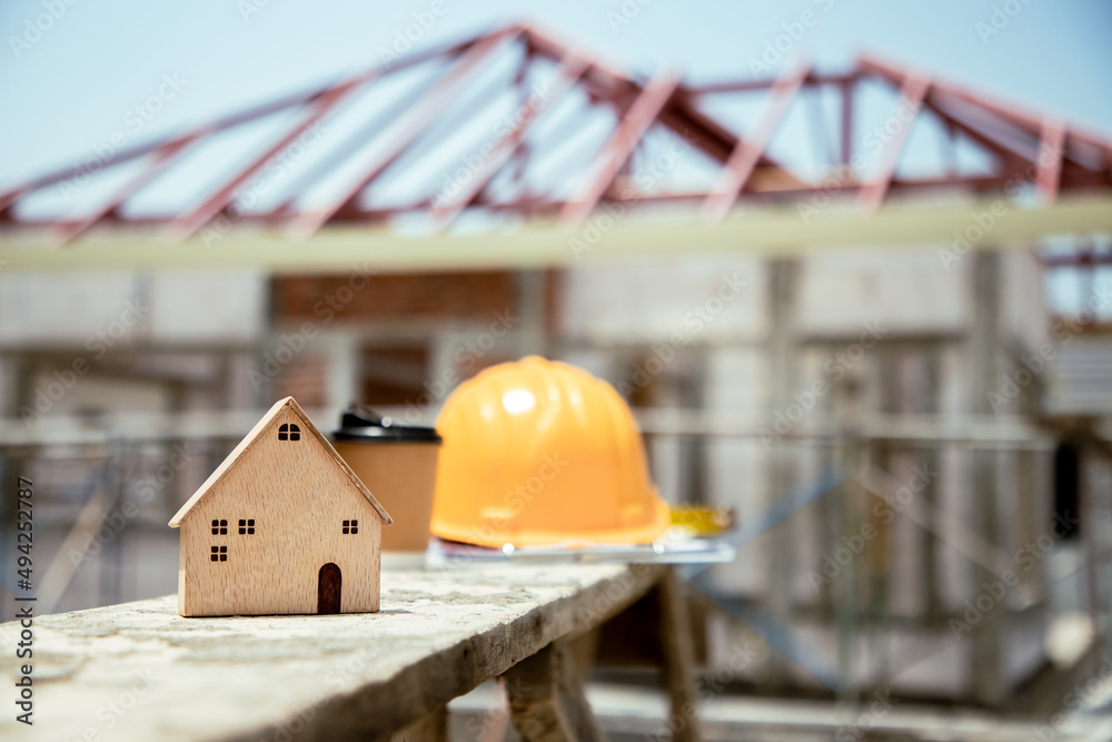 Construction concepts. Yellow safety helmets and sample house model on ...