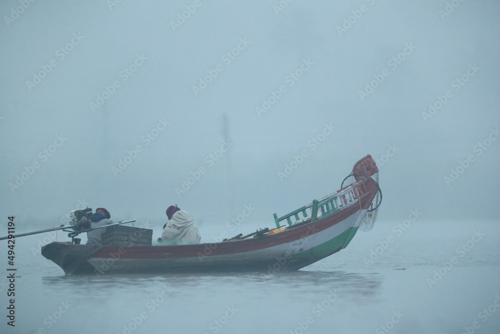 BHIGWAN, INDIA-DECEMBER 31: Fihermen fishing at Bhigwan bird sanctuary ...