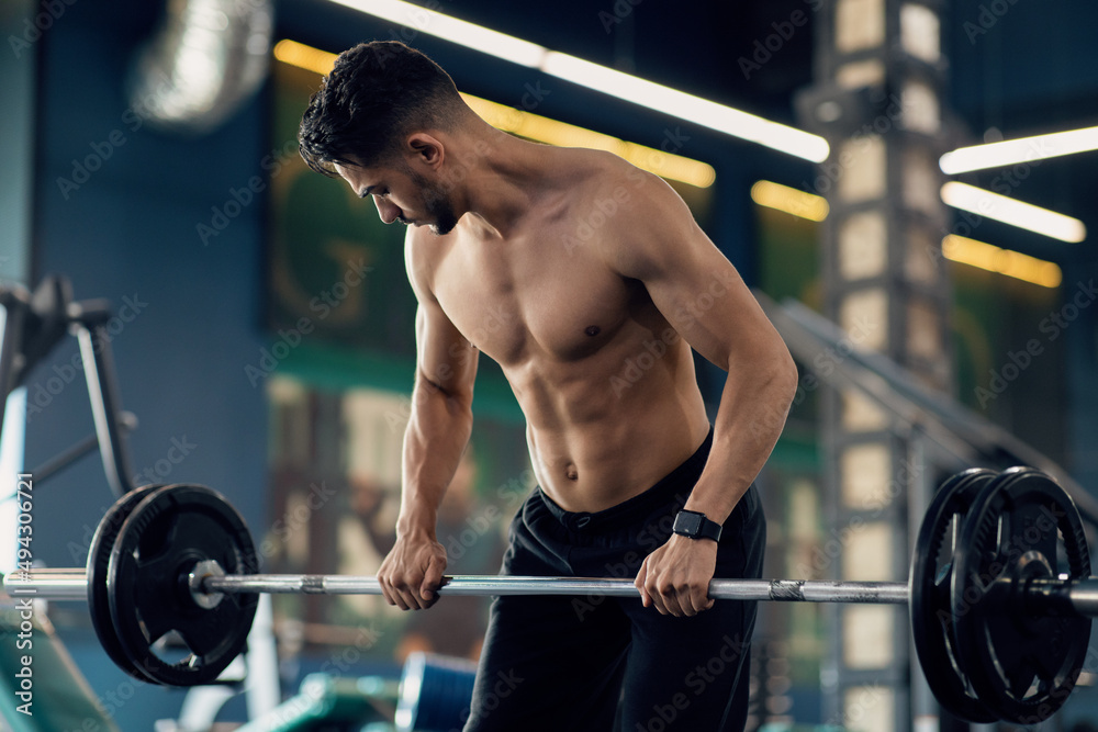 Shirtless Muscular Arab Man Lifting Heavy Barbell While Training At Gym ...