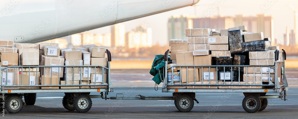Close-up detail view of cargo cart trolley full with commercial parcels ...