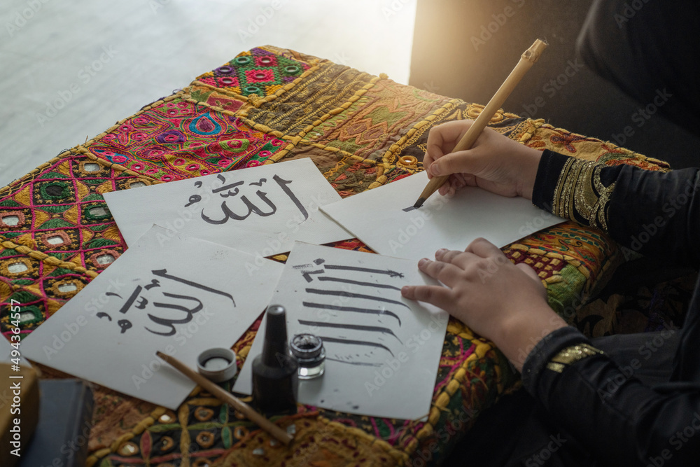 Little Muslim girl wearing black hijab learn to write Arabic alphabet ...