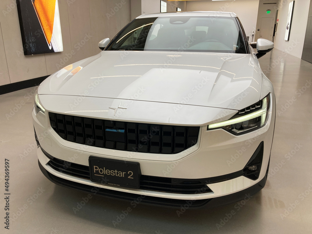 Polestar 2 EV vehicle inside dealership showroom. Front view of ...