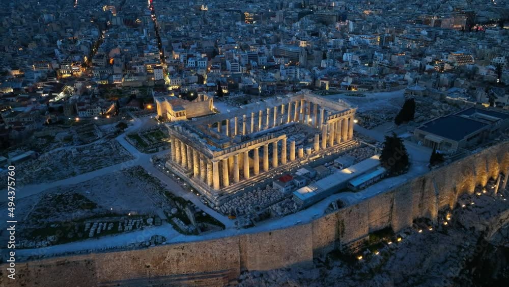 night view of Acropolis in Athens, flying above illuminated Parthenon ...