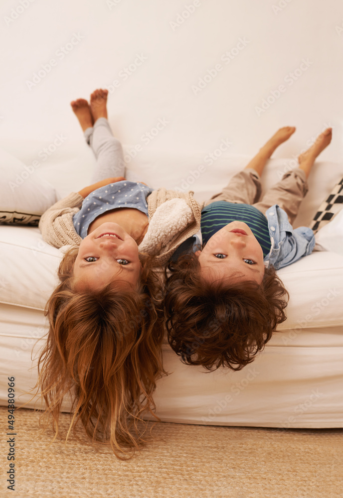 Even upside down were still bored. Portrait of two young children lying ...