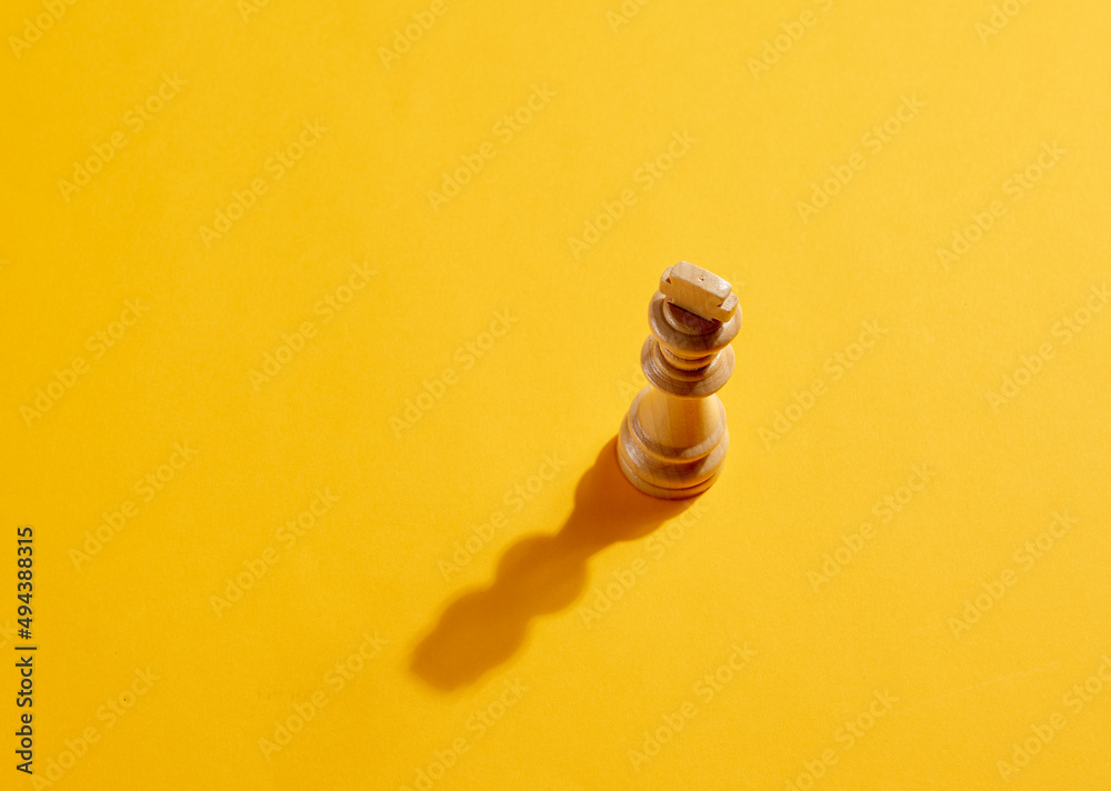 King chess piece on yellow background Stock Photo | Adobe Stock