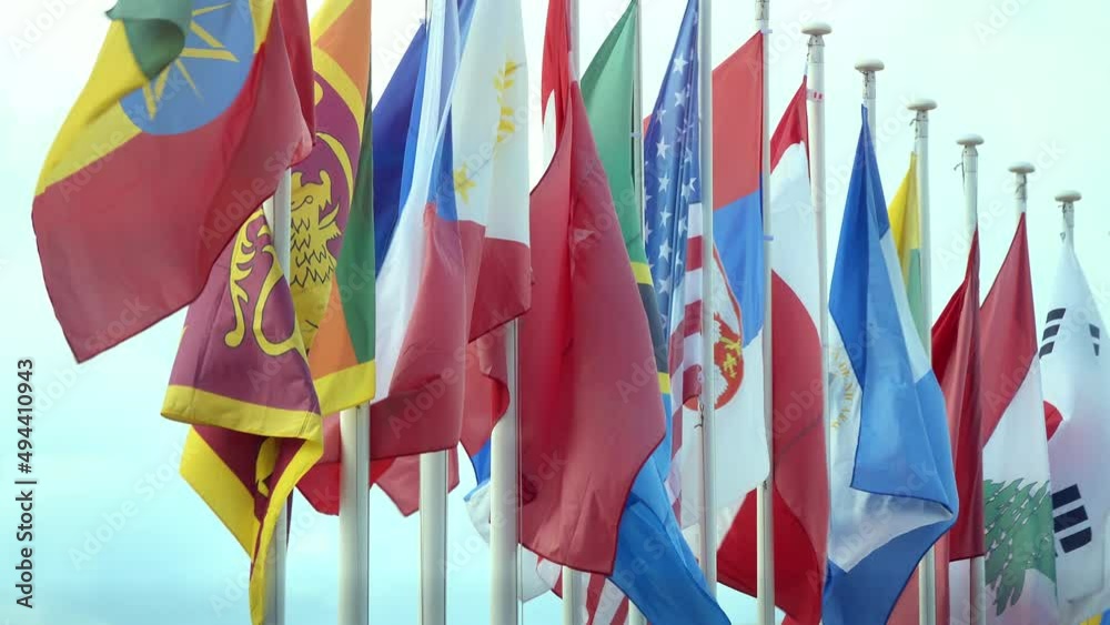 Flags of different countries of the world flutter in the wind against ...