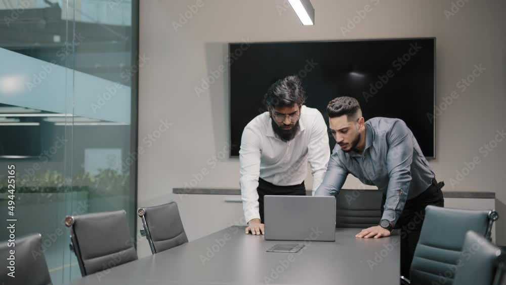 Two male arabs workers managers programmers businessmen stand in office ...
