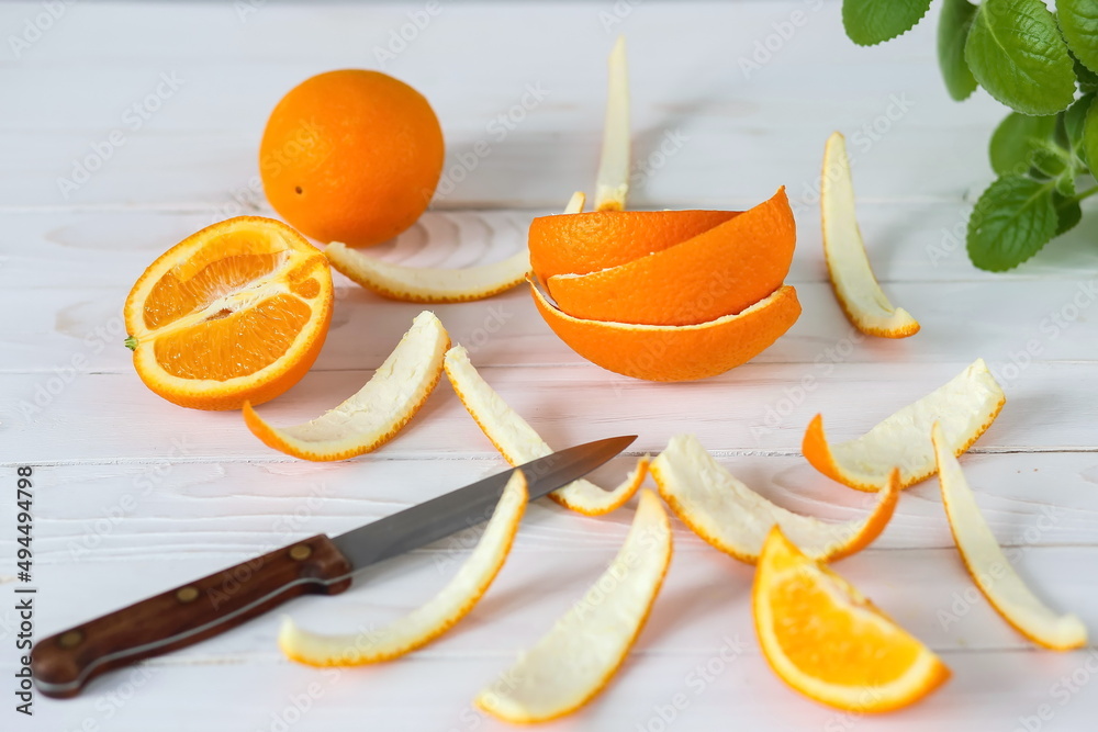 oranges and sliced orange peel on a light background. Homemade orange ...