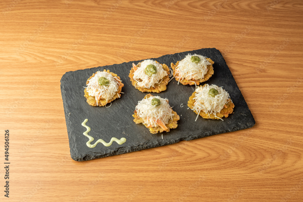 The Venezuelan toston consists of a large piece of green plantain ...