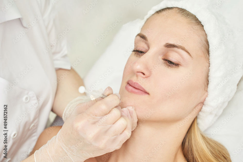 Injection at spa salon. Doctor hands in gloves. Closeup. Pretty female ...