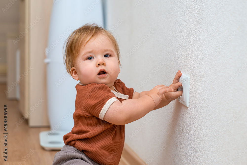 Children's curiosity is a danger to life - baby girl touching a socket ...