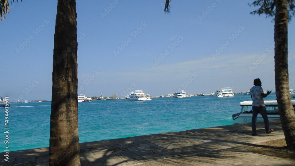 Boats and ships docked at the beautiful crystal clear water port of ...