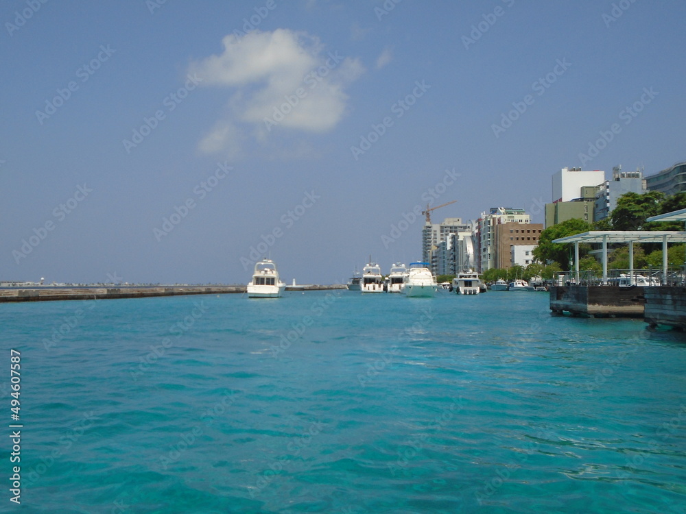 Boats and ships docked at the beautiful crystal clear water port of ...