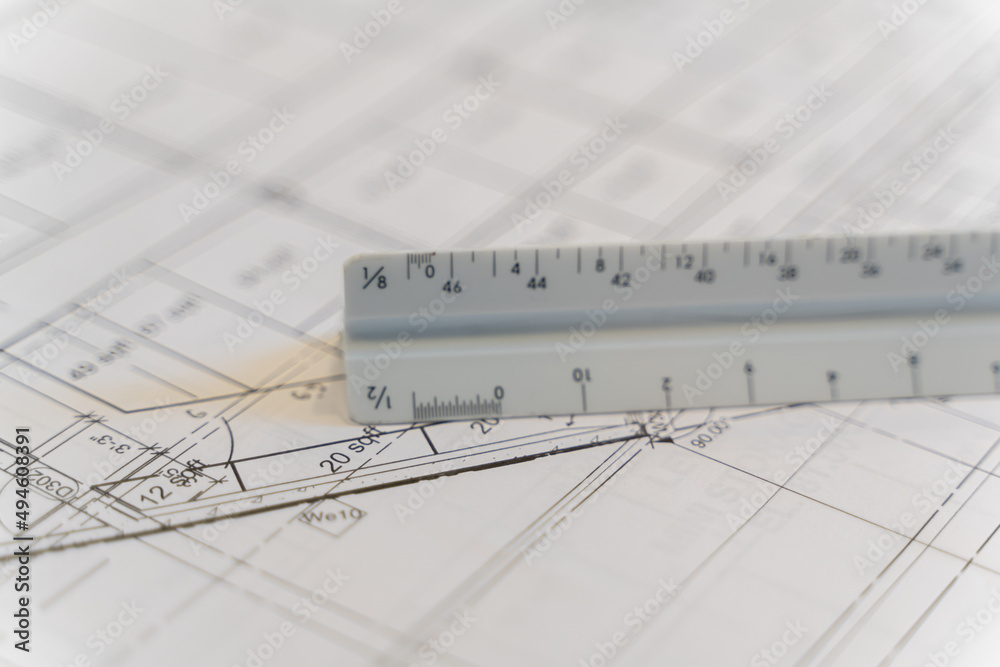 Architectural Scale Ruler with paper blueprints plans for new building ...