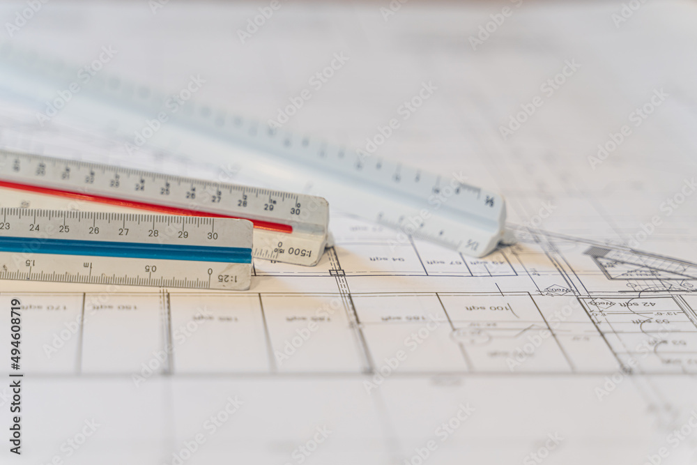 Architectural Scale Ruler with paper blueprints plans for new building ...