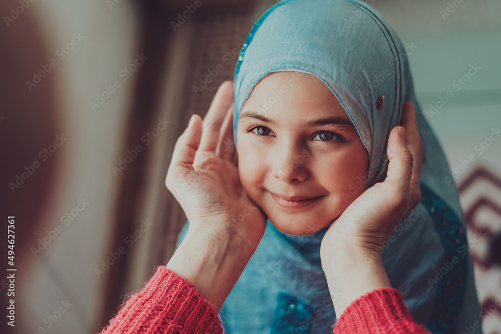 Happy Muslim family. Mother holding child daughter in her hand. Mom and ...