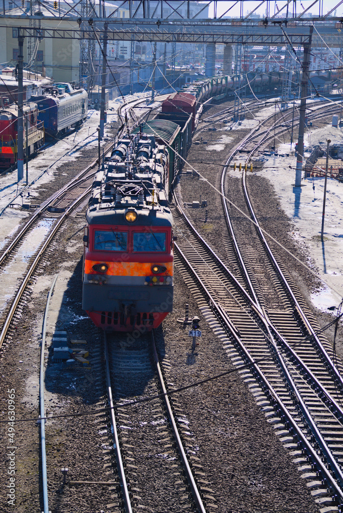 Color street photo with a large freight train. View of the locomotive ...