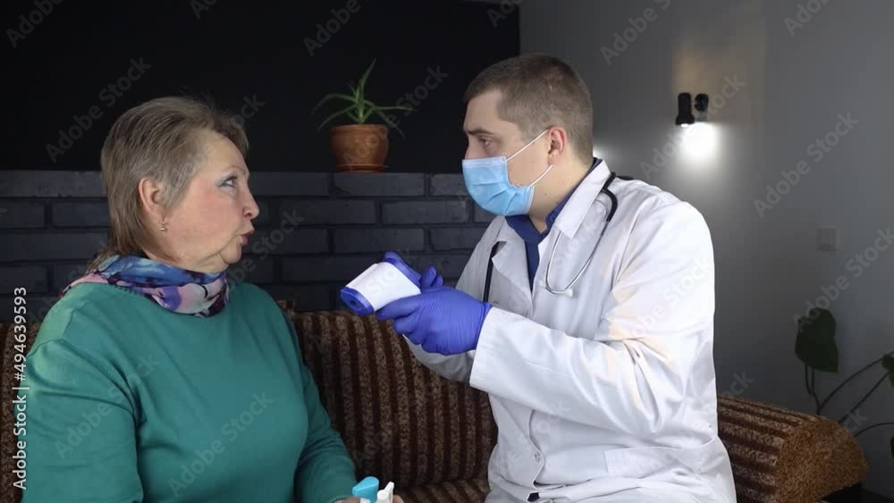 Non-contact thermometer. Doctor measures the body temperature of a ...