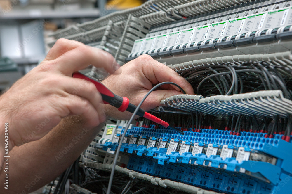 Electrician working on Electrical installations. Electrotechnology ...