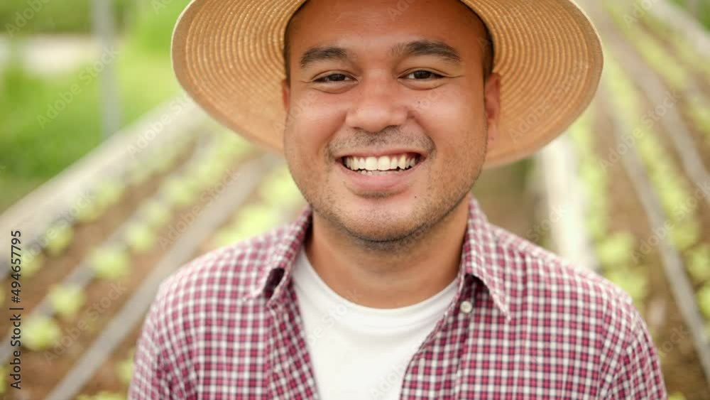 Happy agriculture smiling to the camera with sunlight. Smart farmer ...
